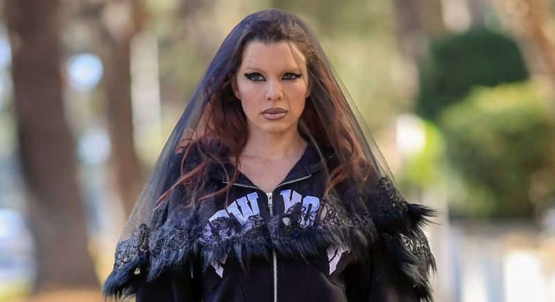 Fox embodies gothic glamour, wearing a veil and high platforms